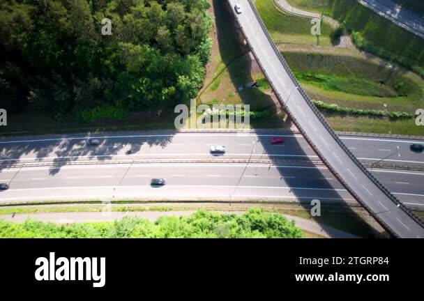 Top down aerial over highway road with flyover in the middle of a ...