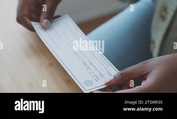 A business woman is preparing to write a check. Salary concept. Payment ...