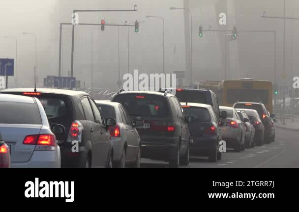 Traffic jam cars standing against green traffic lights in urban scene ...