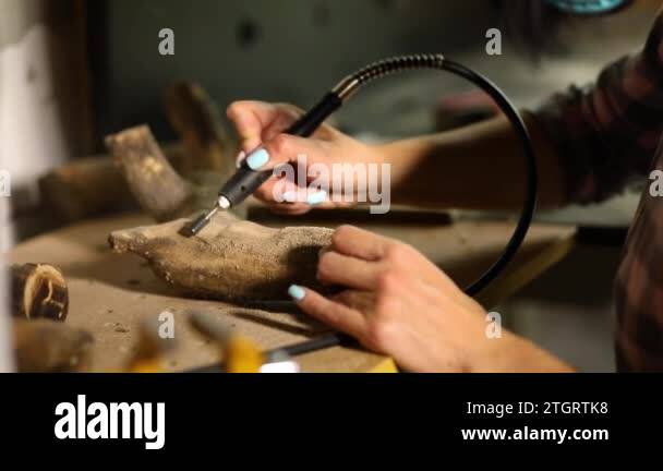 Female using power wood working tools graver, carving while crafting ...