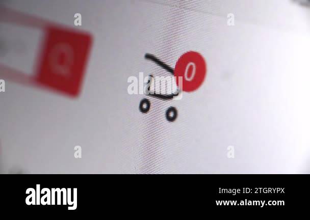 Closeup of mouse cursors click at add to cart button on led computer screen. Close up of mouse ...