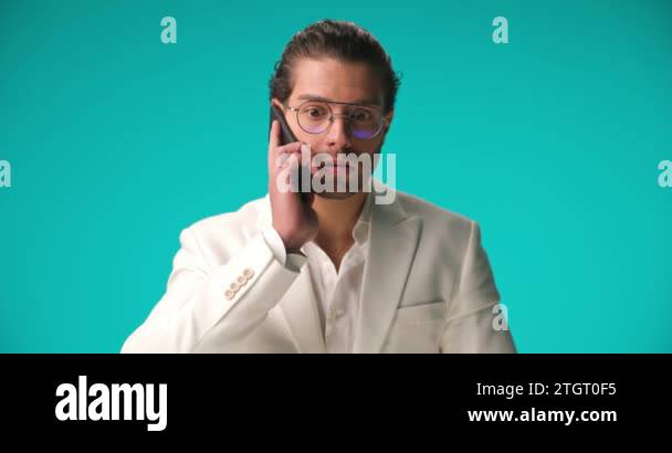 worried Turkish man in white suit with open collar shirt talking on the ...