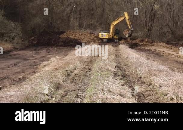 Working with backhoe by digging ground at construction site. Excavator ...