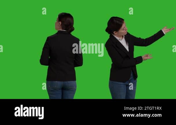 Corporate worker creating new advertisement on camera, pointing sideways to show ad icon or ...