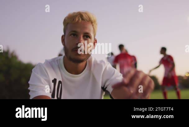 Video of mad biracial football player siting on field. Male football ...