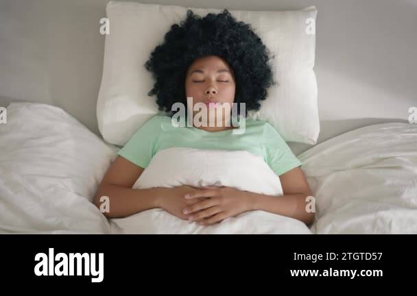 Beautiful African American woman waking up through a nightmare on early ...