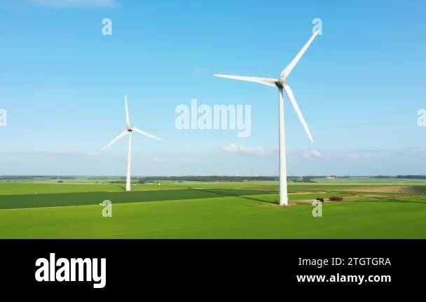 Norman wind turbines in the middle of flax and barley fields, in Europe ...