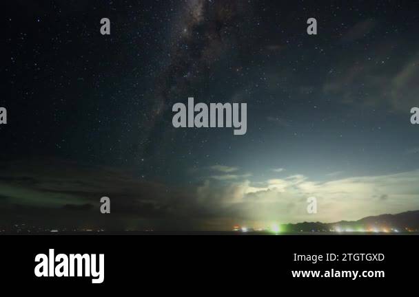 4K Time Lapse Stars Starry Night Sky Milky Way in Bali Indonesia, Clouds Moving and City Light ...