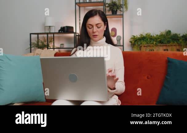 Displeased brunette woman use laptop notebook typing browsing working ...