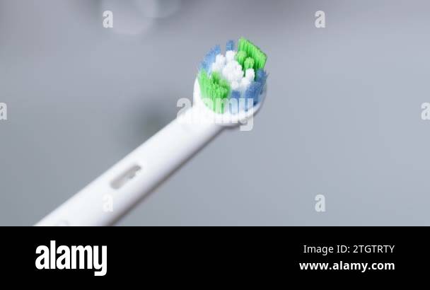 Toothpaste put on electric toothbrush with new head. View of ultrasonic ...
