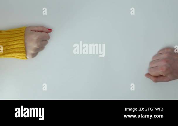 Two hands, male and female, extend their palms to each other. In one ...