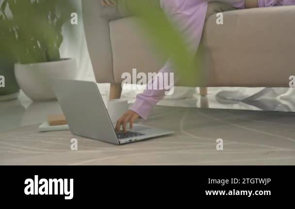 Tilt up shot of relaxed Asian gen Z girl lying on couch at home and ...