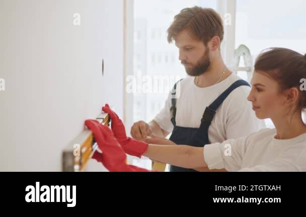 Repair, building and home concept - smiling couple building new home ...