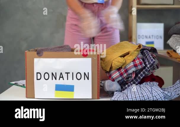 Donation box with Humanitarian aid with things for Ukrainian refugees. Charity and helping the ...