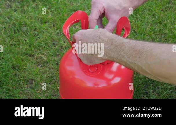 Balon for inflating balloons for a holiday, birthday. A man inflates a ...