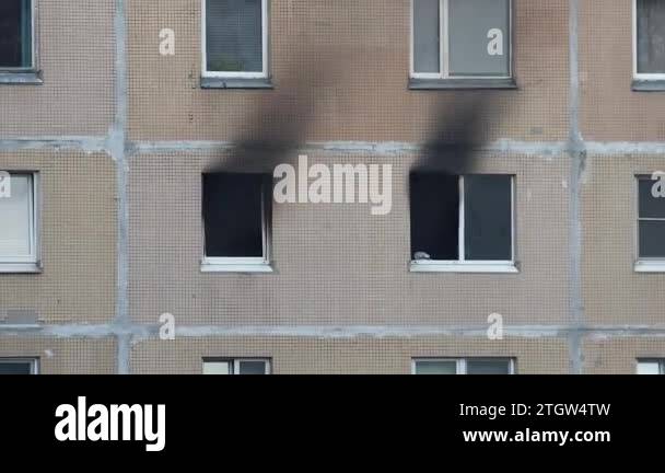 Close-up of black smoke coming out of the windows of two rooms in an ...