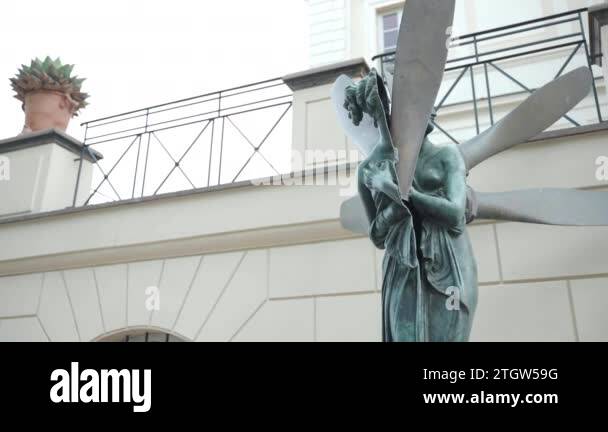 Historic metal statue on the background of white villa palace decorated ...