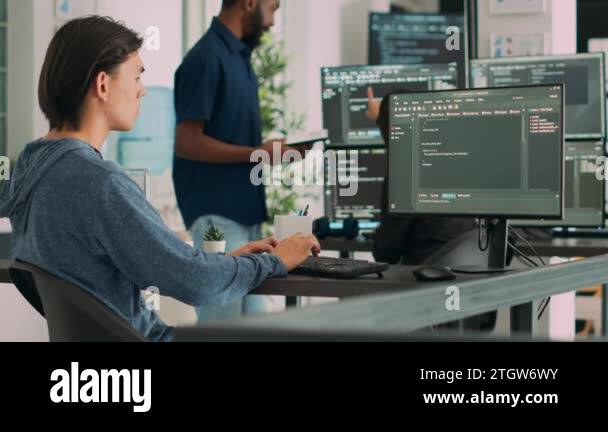 Software Developer Typing Learning App Code On Computer Sitting At Desk In Big Data Office
