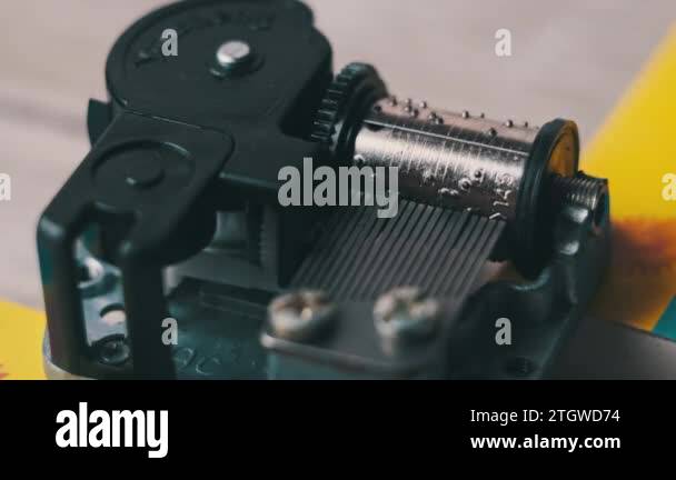 Old music box mechanism with spinning cylinder and cogs in macro. Retro ...