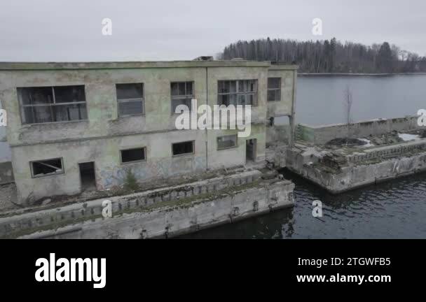 A footage of old and abandoned buildings built on a hydroelectric power ...