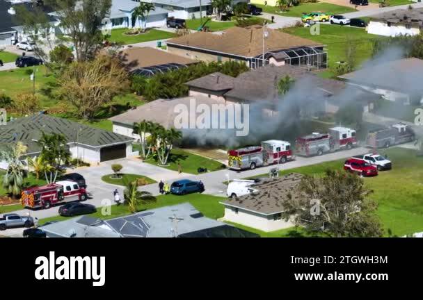 Burning residential house on fire with smoke and flames and ...