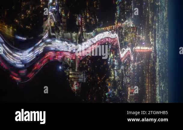 Vertical mobile oriented time lapse bright night motion of speedy night ...