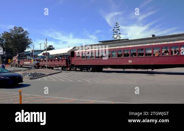 Vintage red tram with text moving at historic Santa Cruz Beach ...