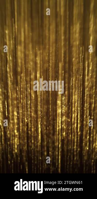 Abstract Gold Filaments Bursting Background/ 4k animation of a vertical ...