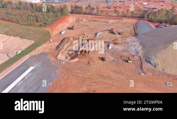 Excavator digging trenches for laying of underground storm sewer pipes ...