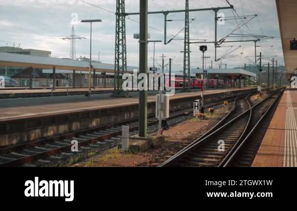 Red modern passenger train arriving to empty railway station. Train ...