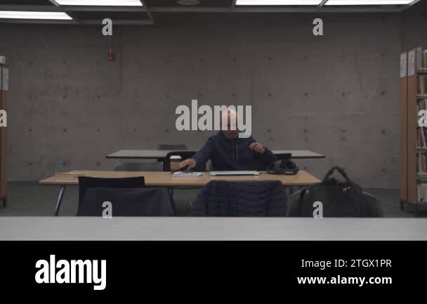 Man sitting inside library in Stock Videos & Footage - HD and 4K Video ...