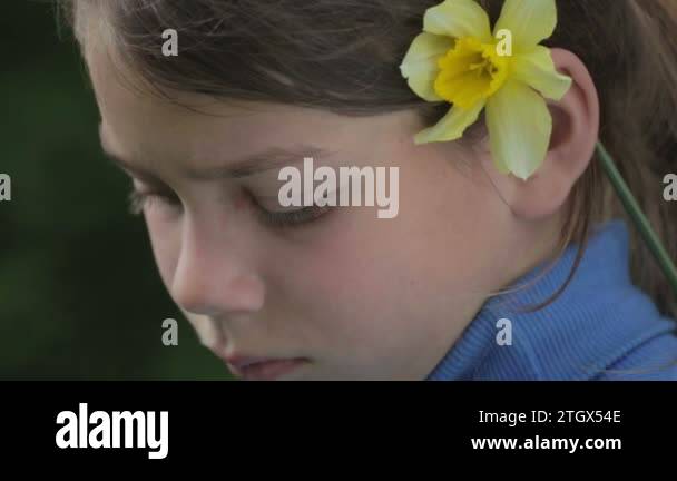 Portrait of a boy in the spring with a flower of yellow narcissus ...