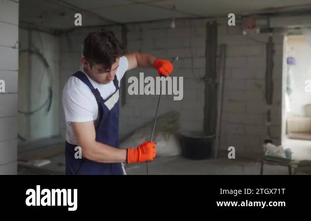 Electrician laying wiring cable, mounting electricity lines in the ...