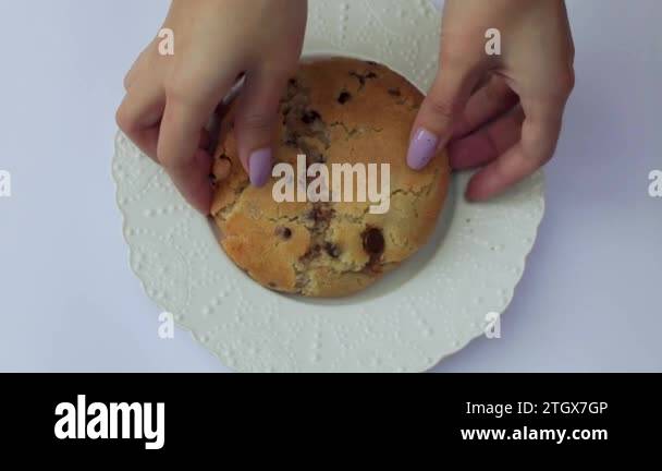 Female hands breaking a huge chocolate chip cookie filled with dulce de ...