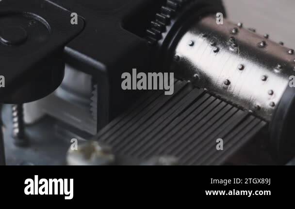 Retro music box mechanism with spinning cylinder and cogs in macro. Old ...