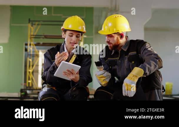 At construction site concentrated discussing with professional engineer ...