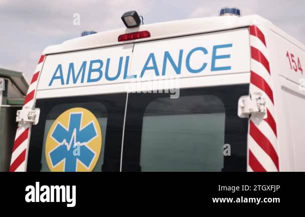 Ambulance van on wide city street. White emergency vehicle with warning ...