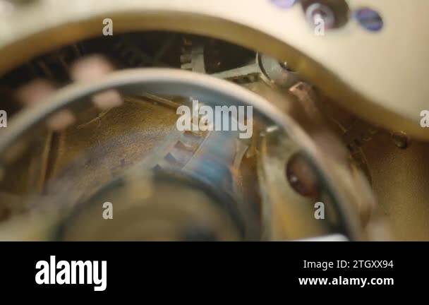 Moving gold gears inside working pocket watch mechanism. Working clock ...