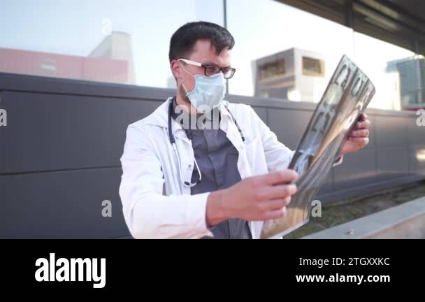 Male doctor examines x-ray of patient chest with CT scan film ...