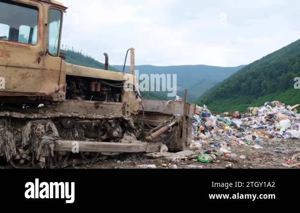 Landfill of unsorted garbage, a tractor at a landfill. Lots of plastic ...