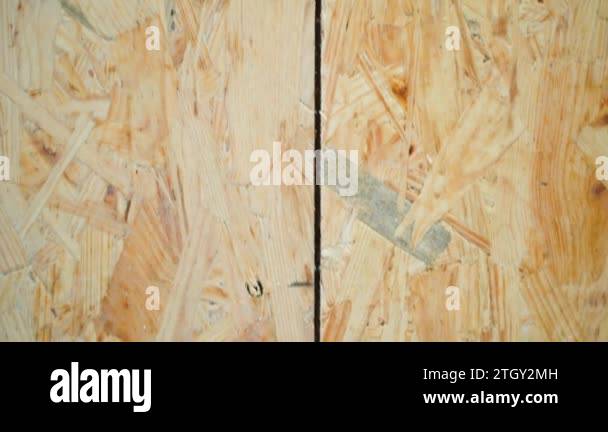 Close-up of uniform gap between oriented strand boards. The gap is ...