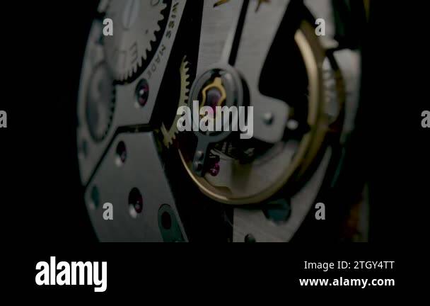 Disassembled vintage pocket watch with clockwork turning on black ...