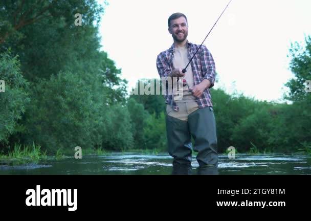 Fisherman with fishing rod on the river. Brown trout fish. Summer ...