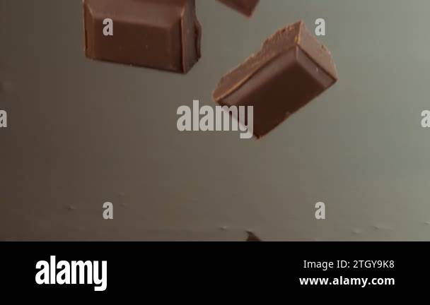 Super Slow Motion of Falling Chocolate Pieces into Melted Chocolate ...