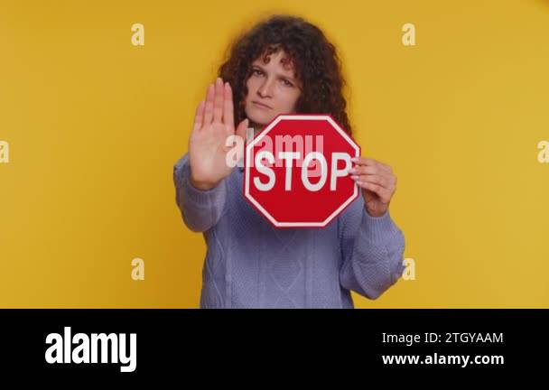 Serious curly haired woman say No, hold inscription text red stop ...