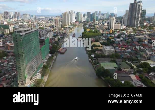 An aerial of crowded residential buildings and Pasig River in the ...