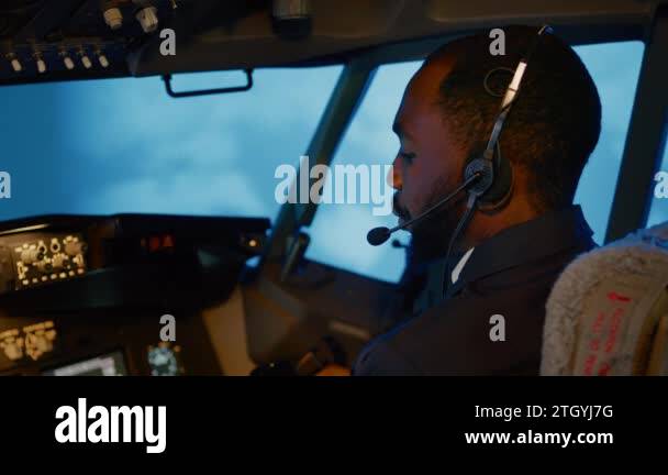African american copilot using airplane command to fly plane ...