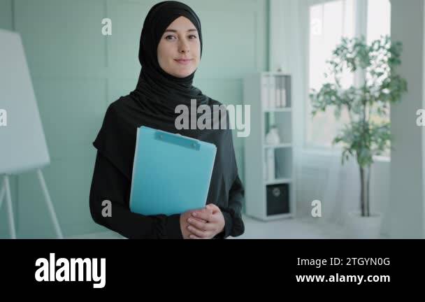 Islamic Indian lady Muslim girl intern standing at modern office ...