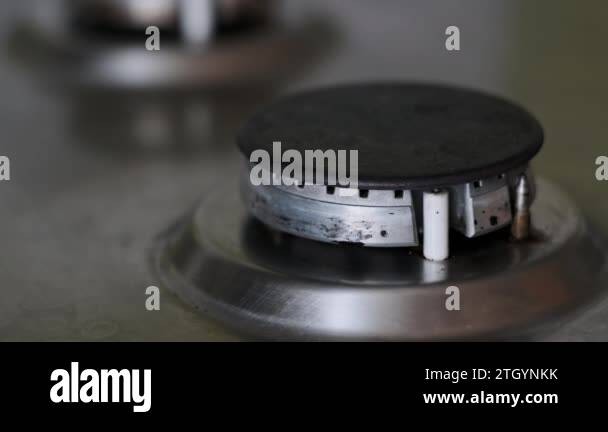 Fire in the gas burner is lit in slowmo. The flame of an electric ...