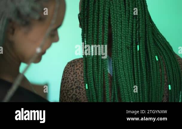 Two young black latina women showing their braided hair. Hispanic girls ...